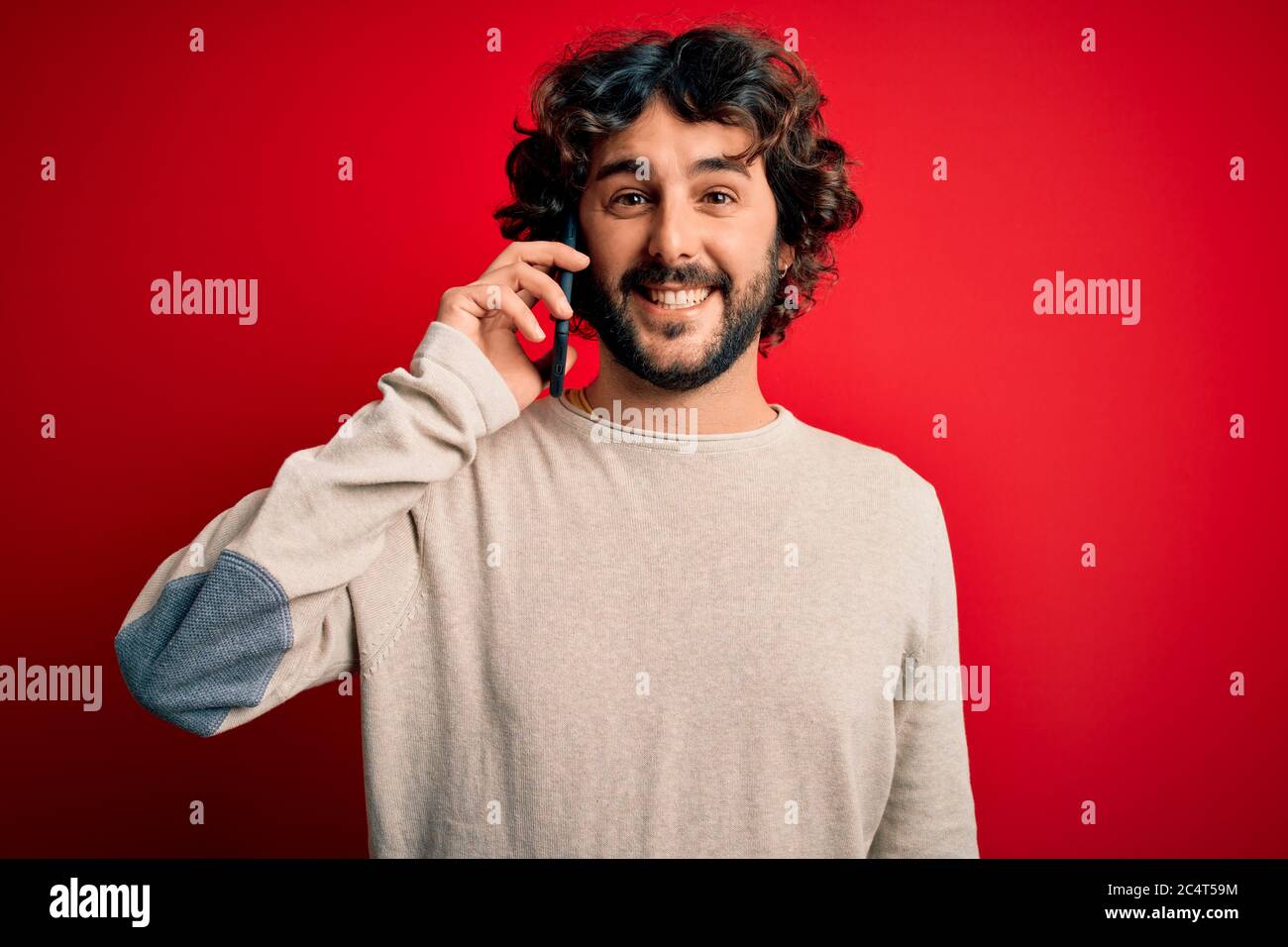 Handsome man with beard having conversation talking on the smartphone ...