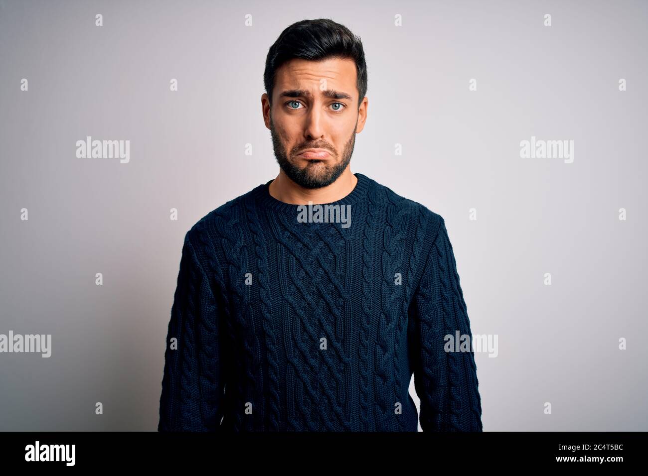 Young handsome man with beard wearing casual sweater standing over ...