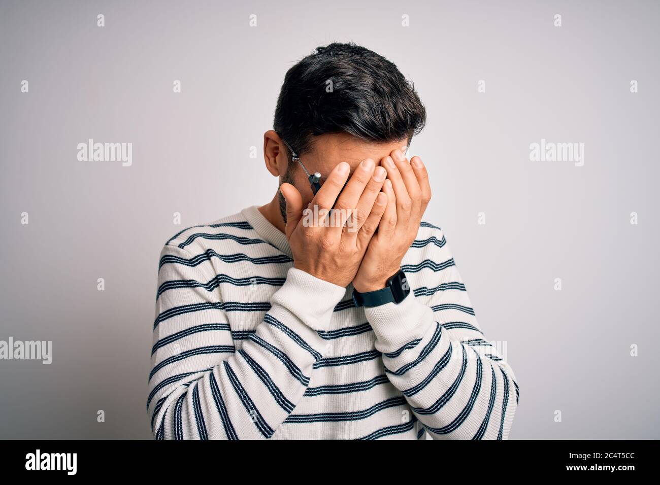 Young handsome man with beard wearing optometry glasses over isolated ...