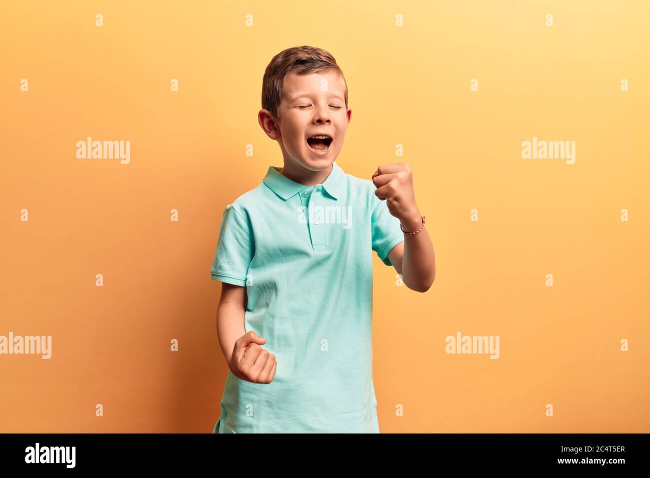 Cute blond kid wearing casual clothes celebrating surprised and amazed ...