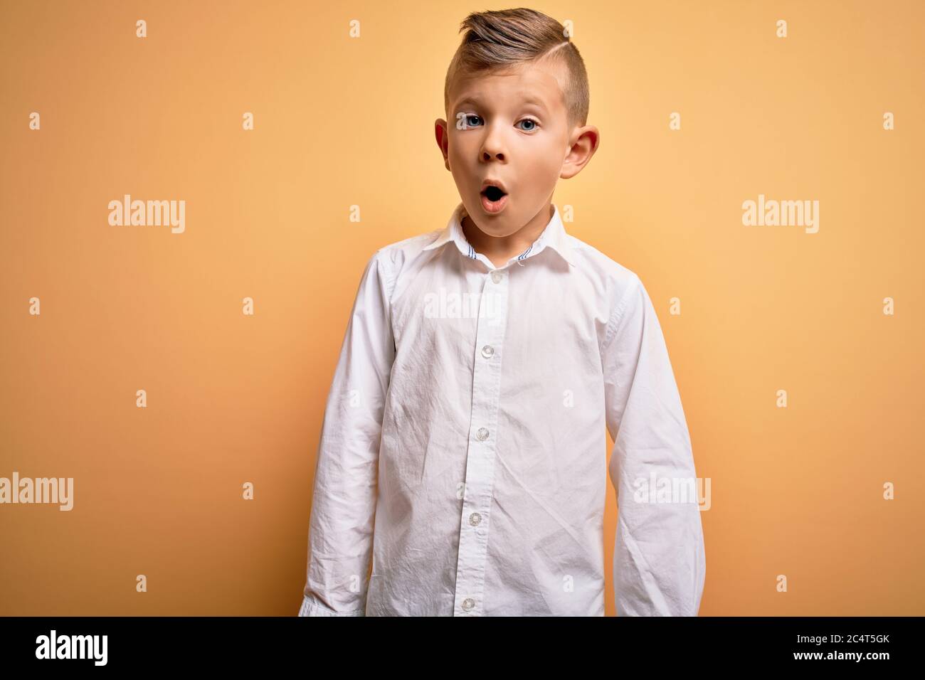 Young little caucasian kid with blue eyes wearing elegant white shirt ...
