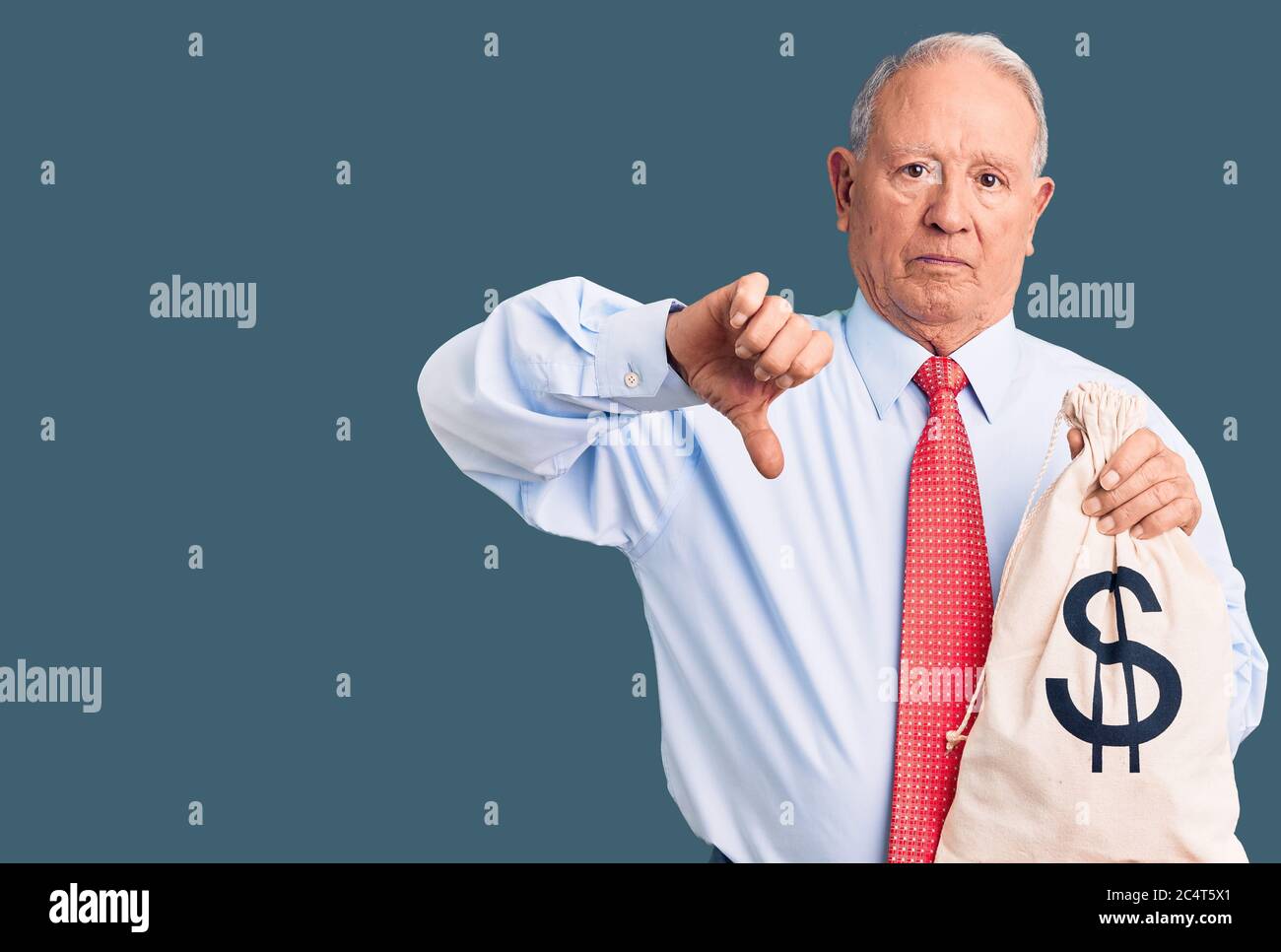 Senior handsome grey-haired man wearing elegant clothes holding money ...