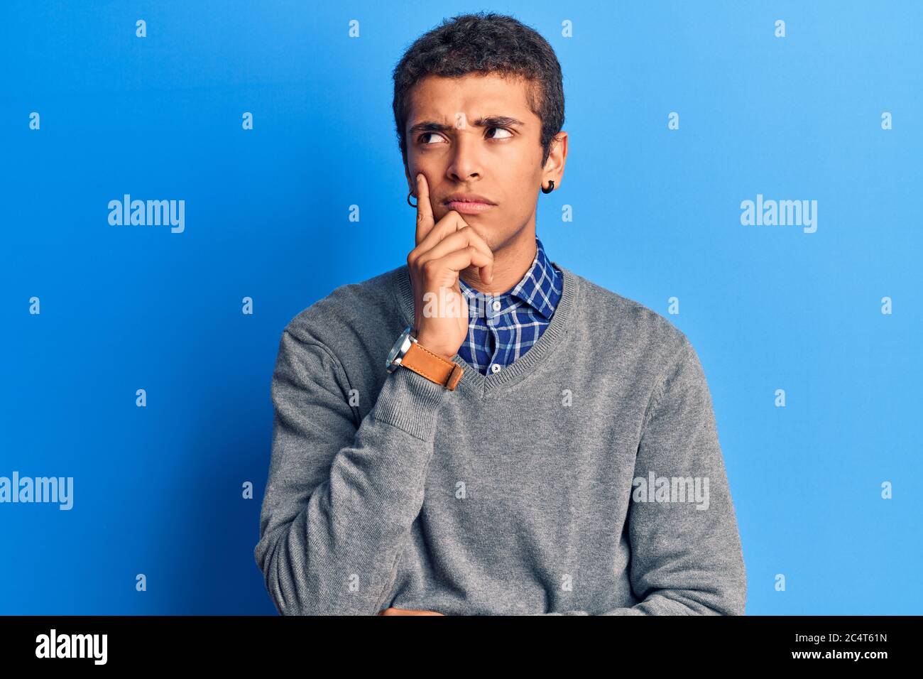 Young african amercian man wearing casual clothes serious face thinking ...