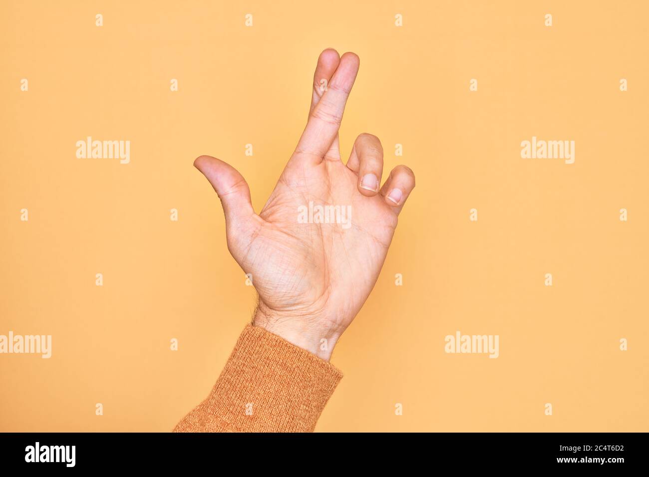 Hand of caucasian young man showing fingers over isolated yellow ...