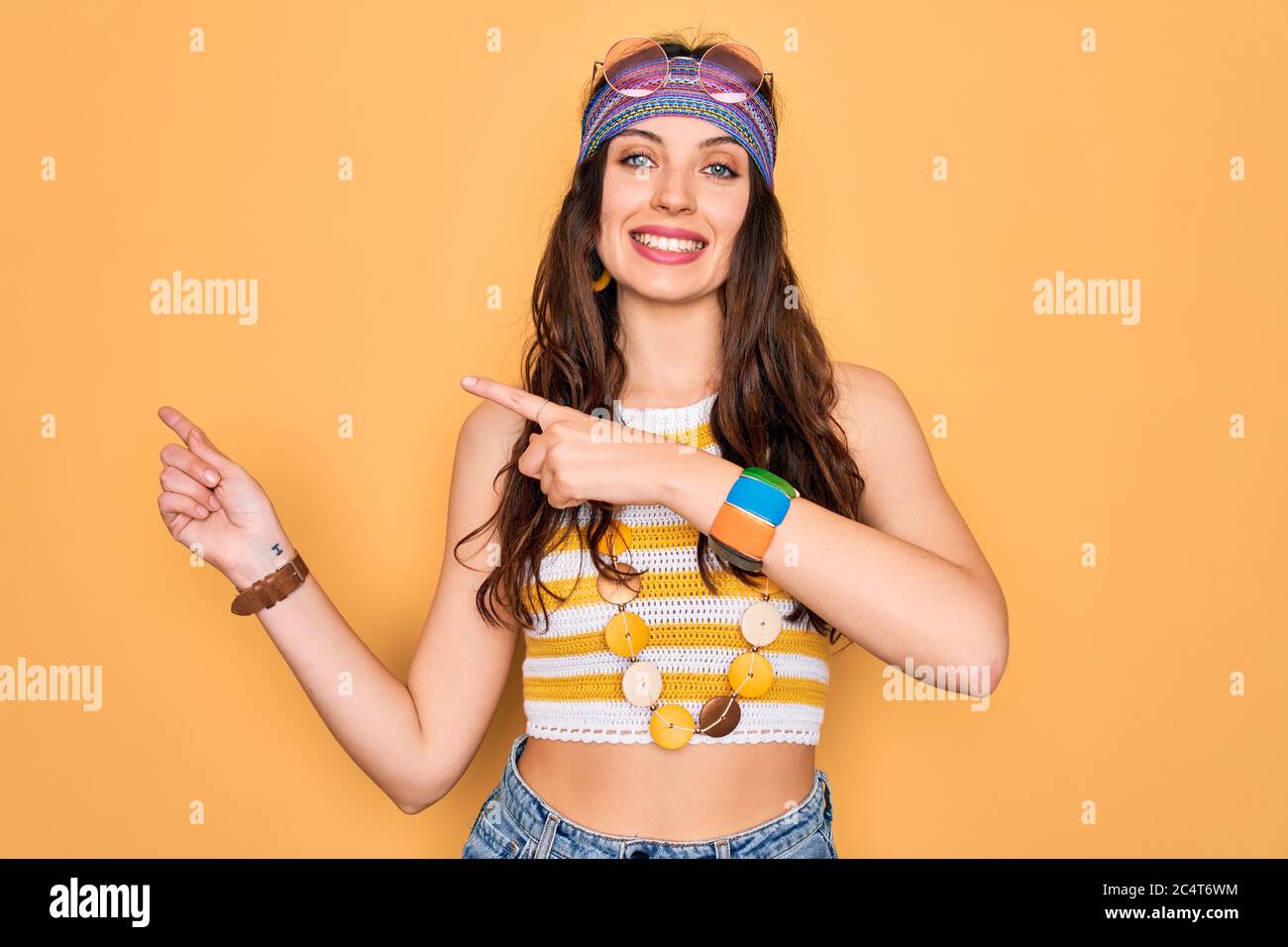 Young beautiful hippie woman with blue eyes wearing accesories and ...
