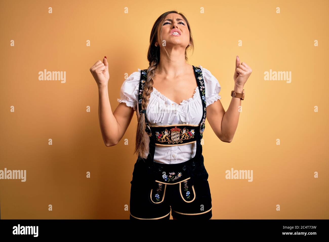 Young beautiful brunette german woman celebrating Octoberfest wearing ...