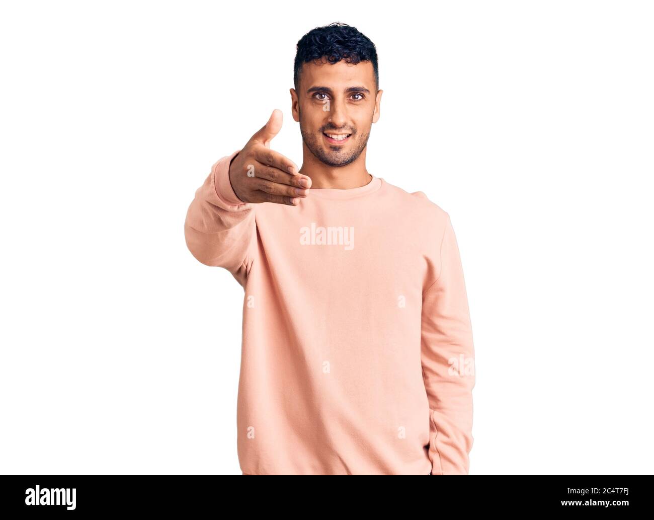 Young hispanic man wearing casual clothes smiling friendly offering ...