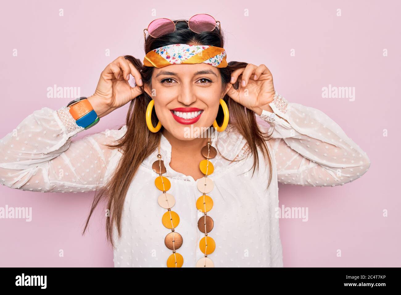 Young hispanic hippie woman wearing fashion boho style and sunglasses ...