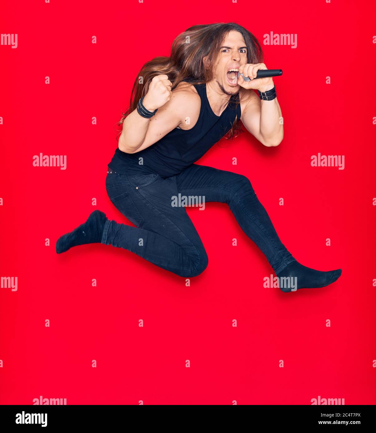 Young handsome heavy metal singer man with long hair and aggressive ...