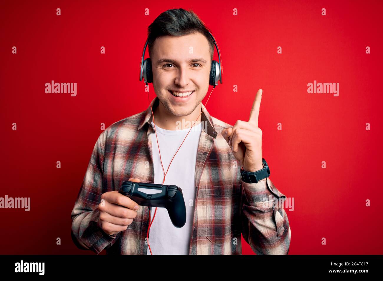 Young handsome caucasian gamer man playing video games using console ...