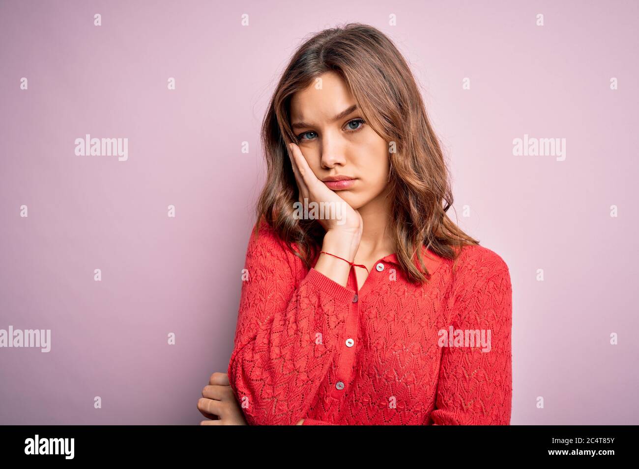 Young beautiful blonde casual girl over pink isolated background ...