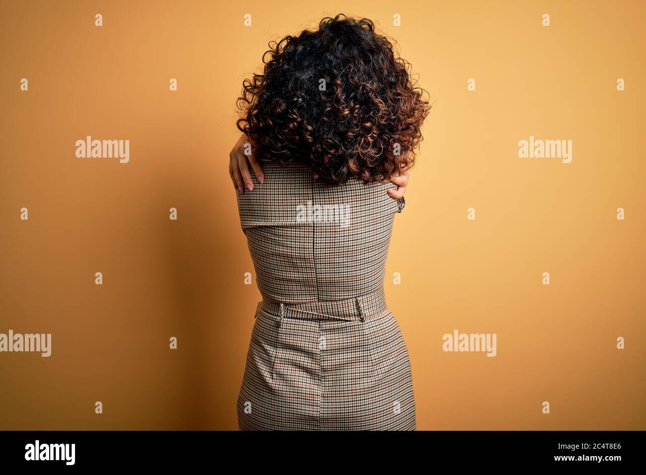 Beautiful arab business woman wearing dress and glasses standing over ...