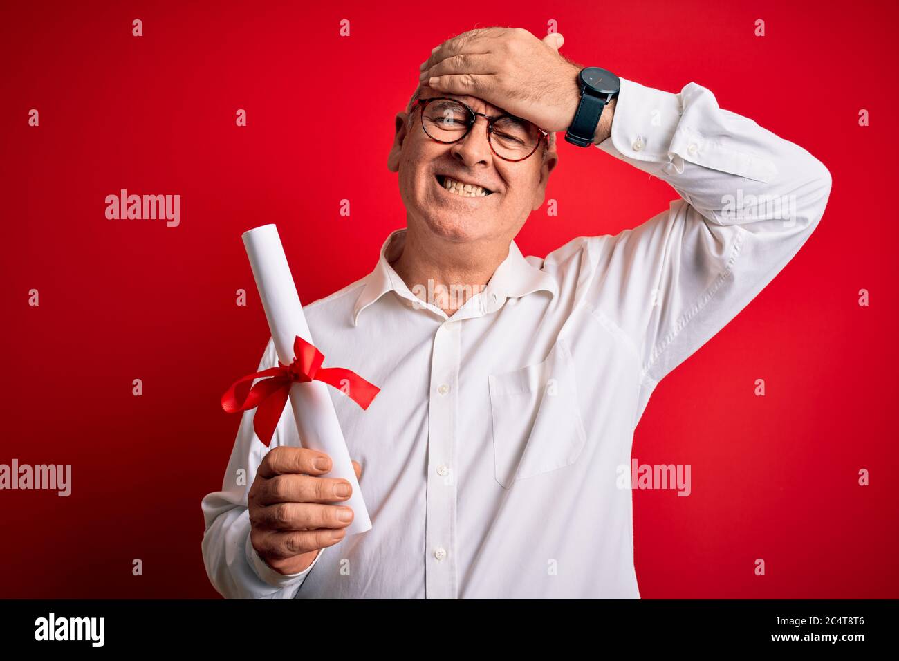 Middle age hoary student man wearing glasses holding university ...