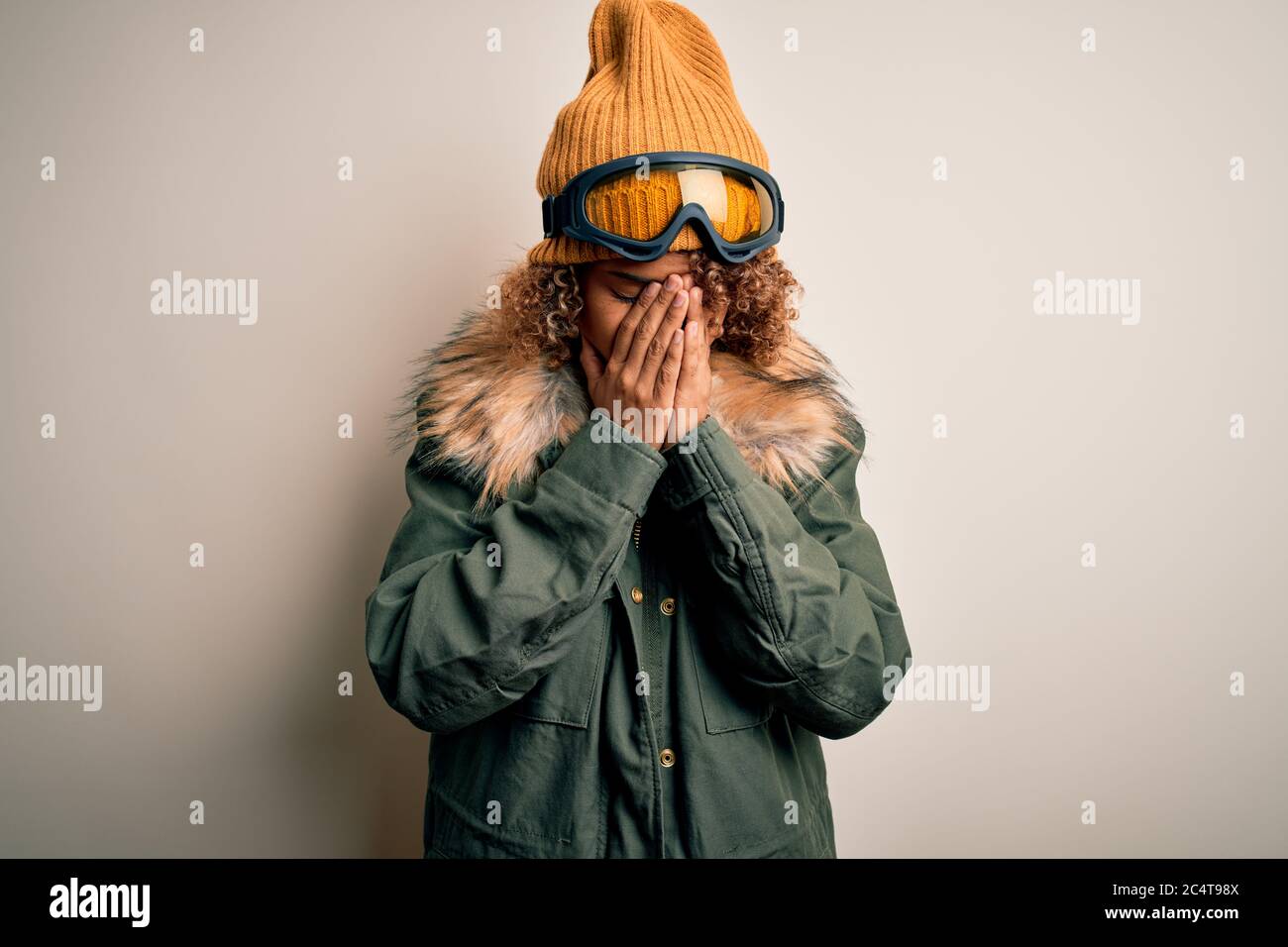 Young african american skier woman with curly hair wearing snow ...