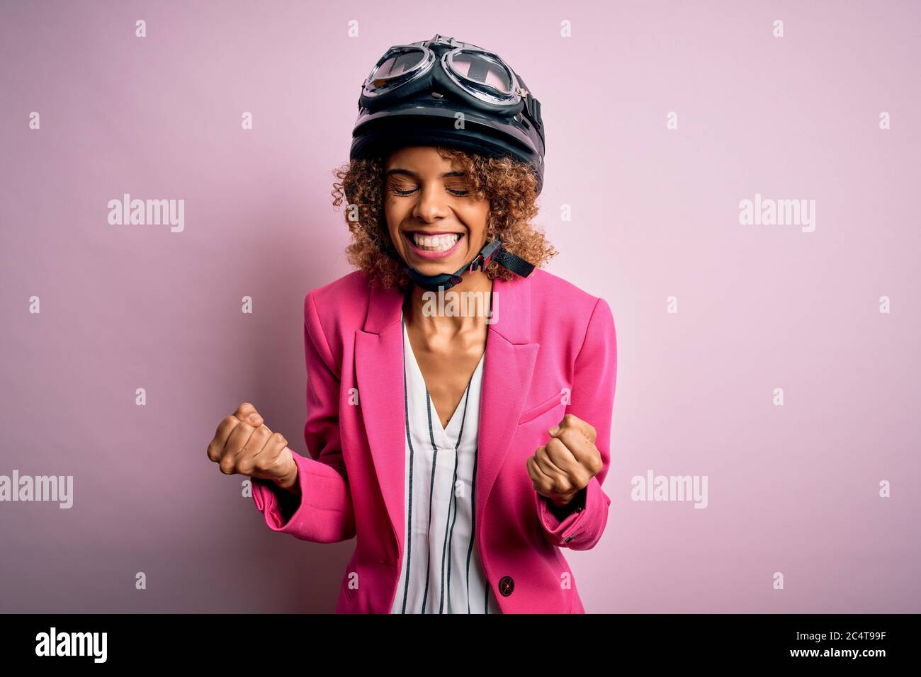 African american motorcyclist woman with curly hair wearing moto helmet ...