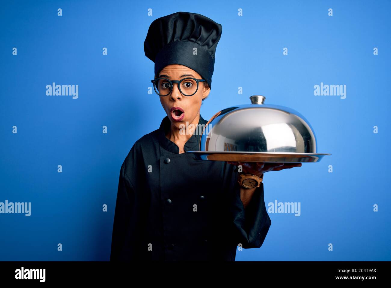 Young african american cooker woman wearing uniform holding waiter tray ...
