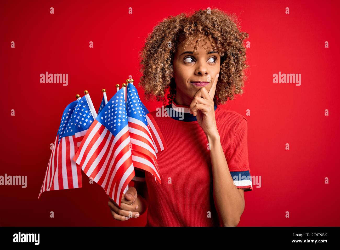 Young african american patriotic curly woman holding united states ...