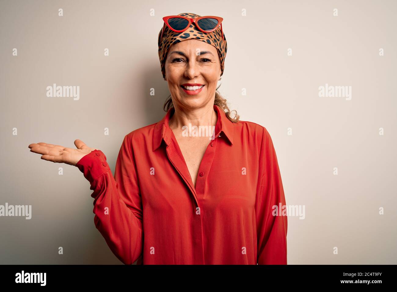 Middle age brunette woman wearing handkerchief on head and shirt over ...