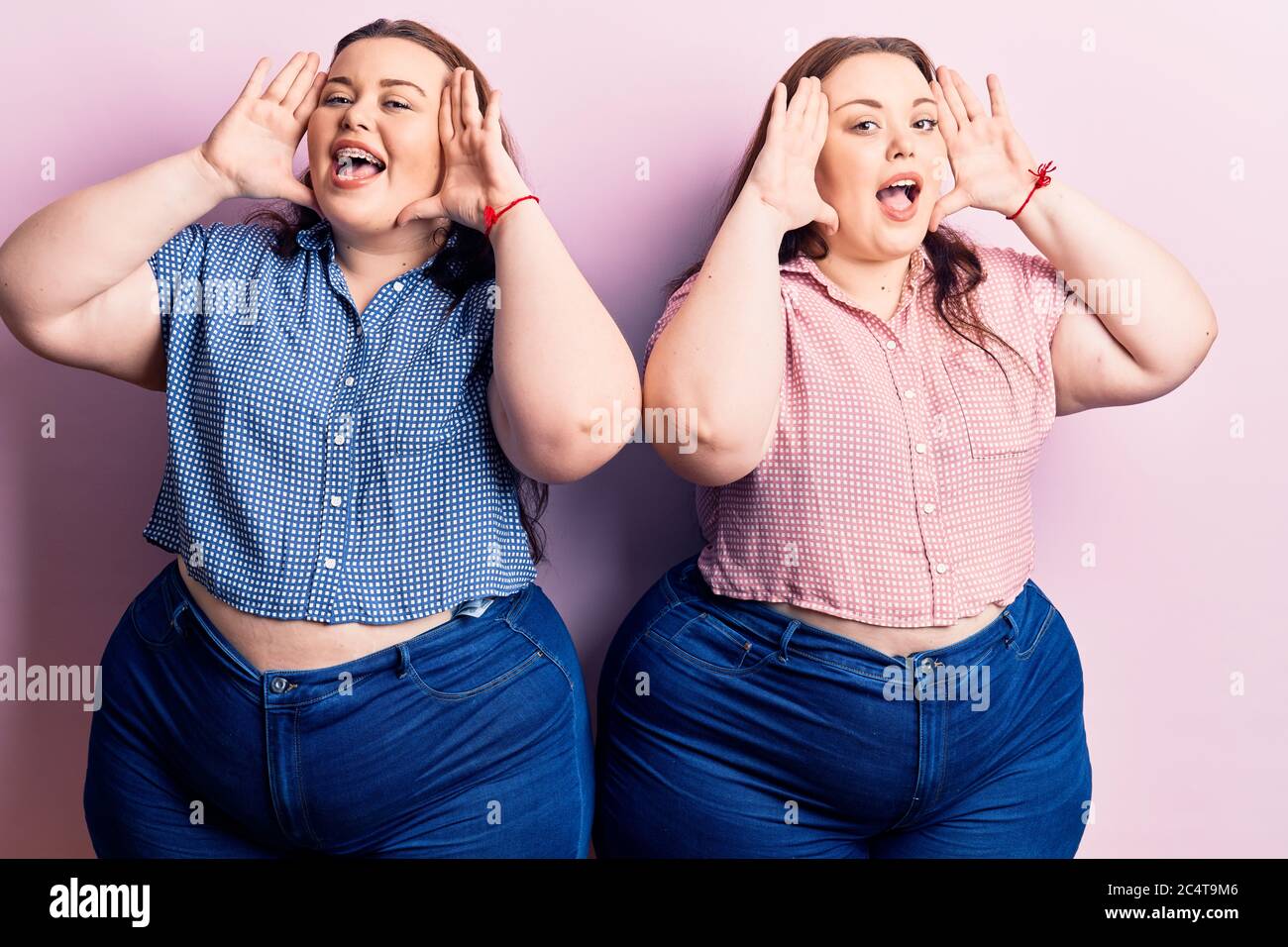 Young plus size twins wearing casual clothes smiling cheerful playing ...