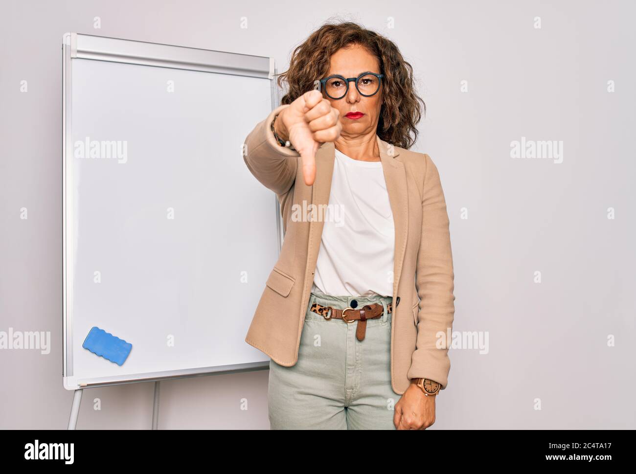 Middle age senior business woman standing on seminar presentation by ...