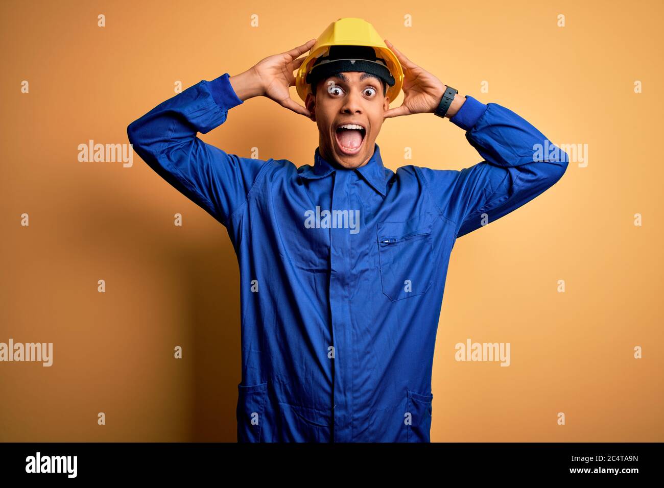 Young handsome african american worker man wearing blue uniform and ...