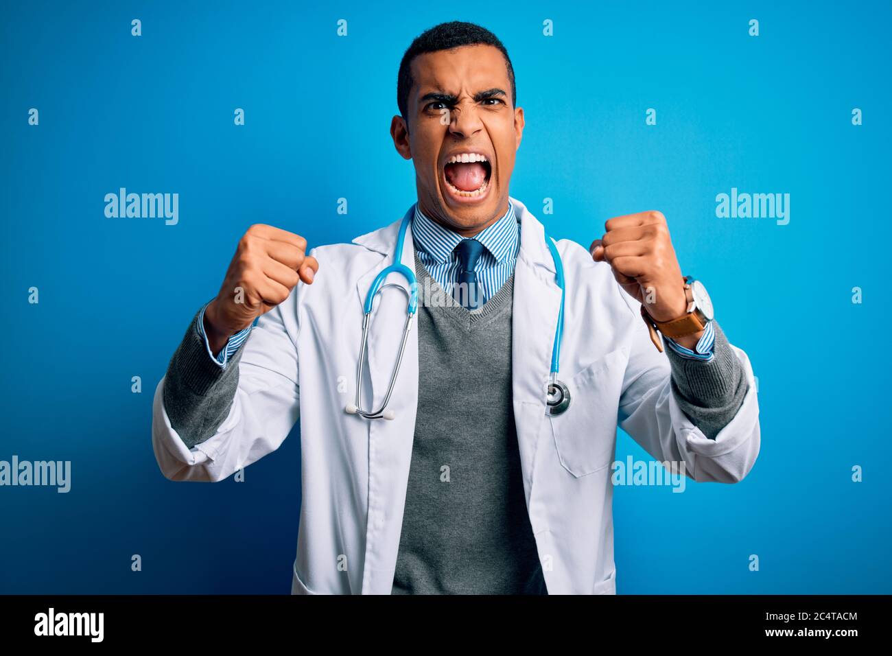 Handsome african american doctor man wearing coat and stethoscope over ...