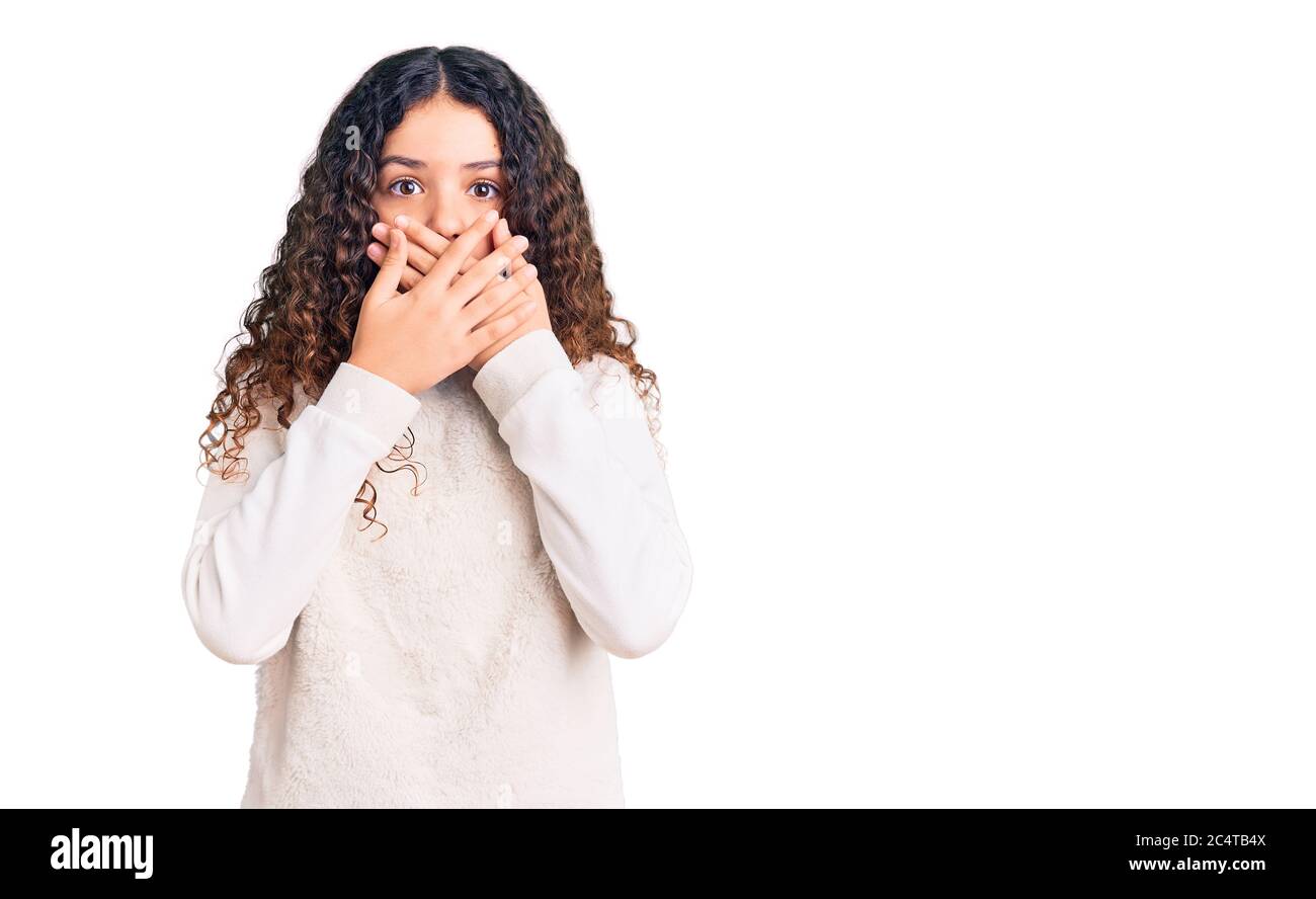 Beautiful kid girl with curly hair wearing casual clothes shocked ...
