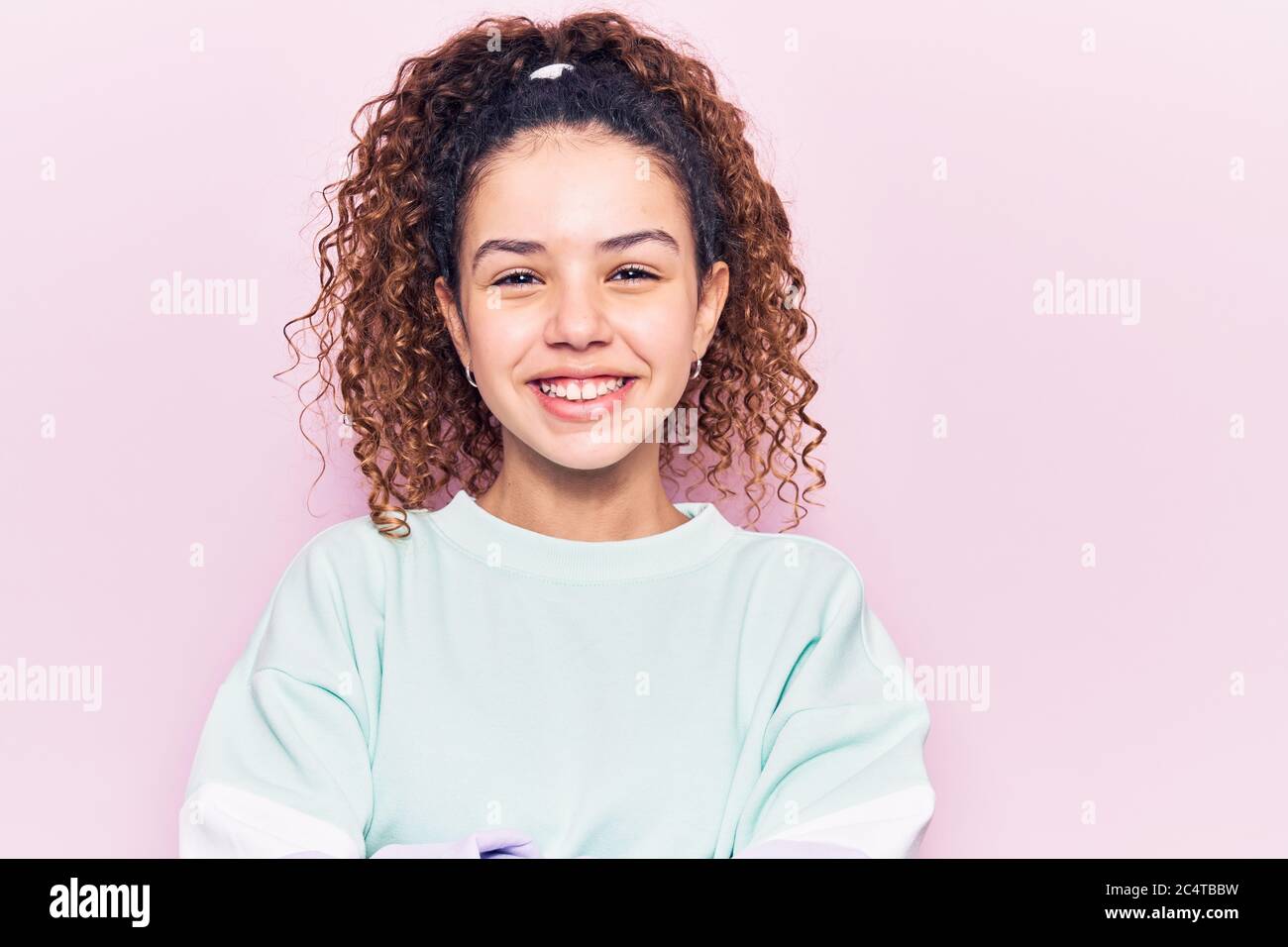 Beautiful kid girl with curly hair wearing casual clothes happy face ...