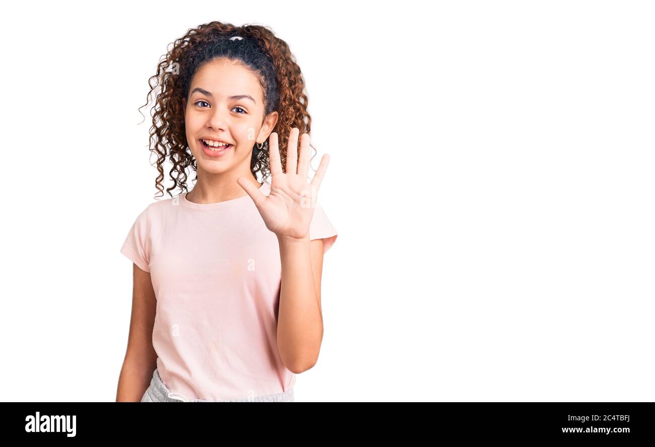 Beautiful kid girl with curly hair wearing casual clothes showing and ...