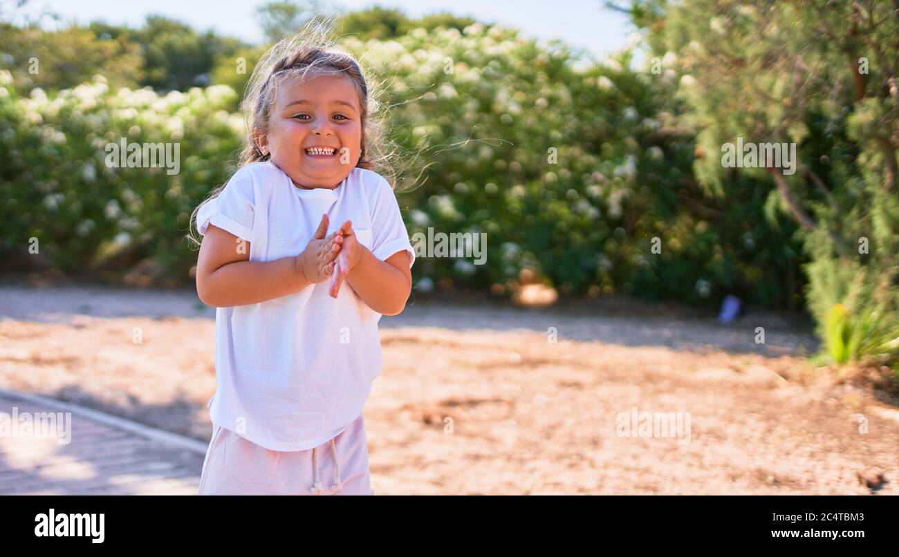 Adorable blonde child smiling happy. Standing with smile on face ...