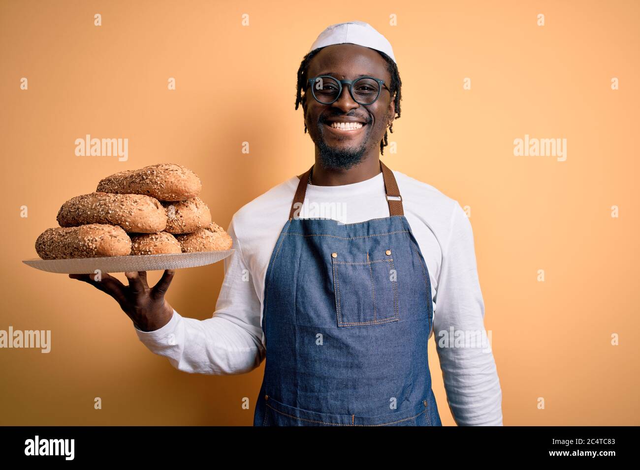 Young african american bakery man holding tray with healthy wholemeal ...