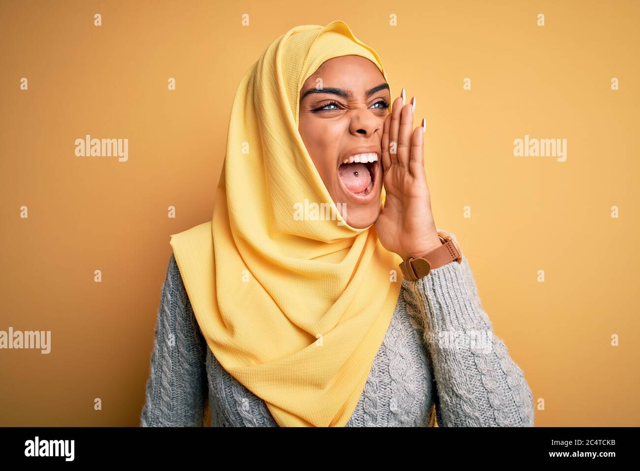 Young beautiful african american girl wearing muslim hijab over ...