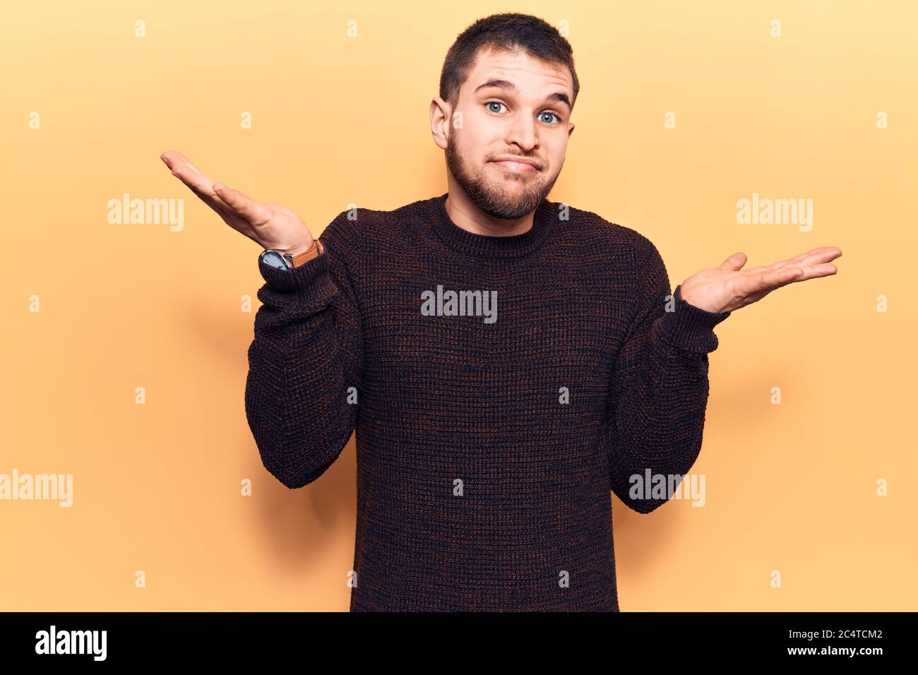 Young handsome man wearing casual sweater clueless and confused with ...