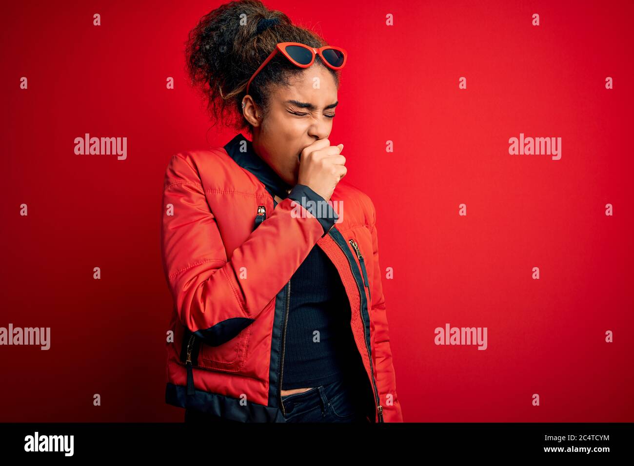 Beautiful african american girl wearing red jacket and sunglasses over ...