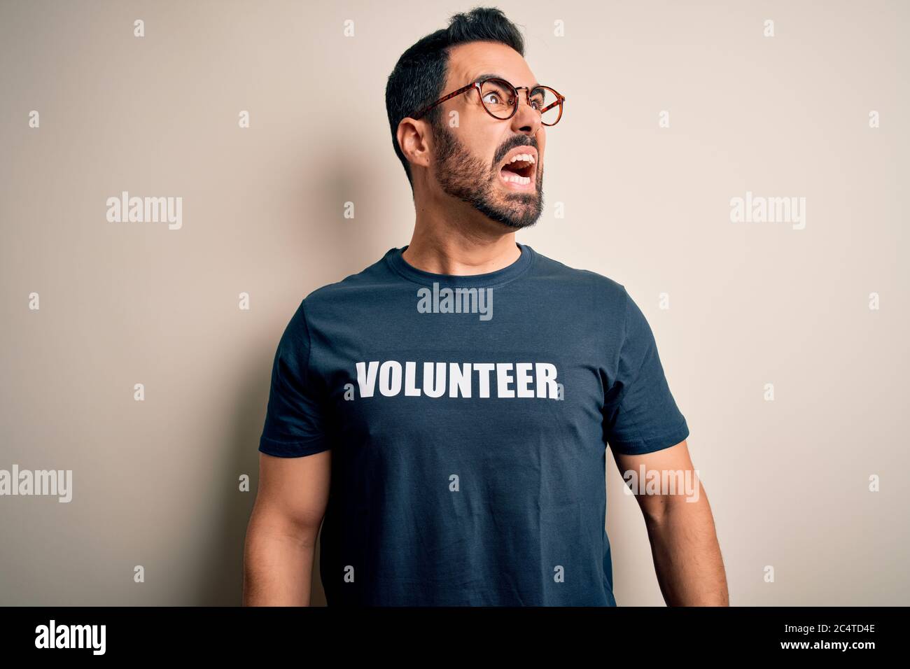 Handsome man with beard wearing t-shirt with volunteer message over ...
