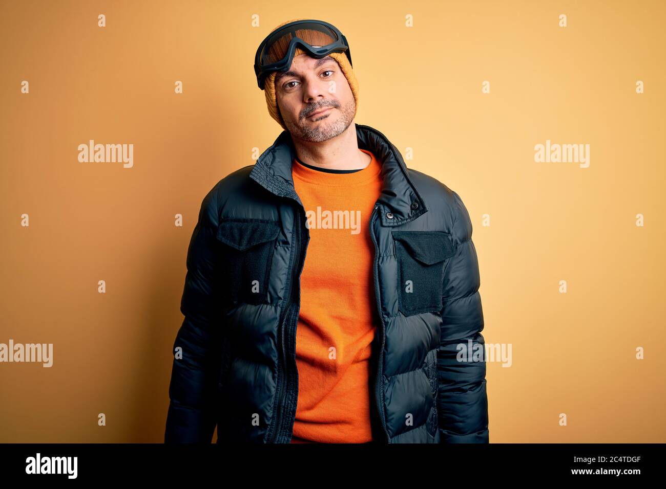 Young handsome skier man skiing wearing snow sportswear using ski ...