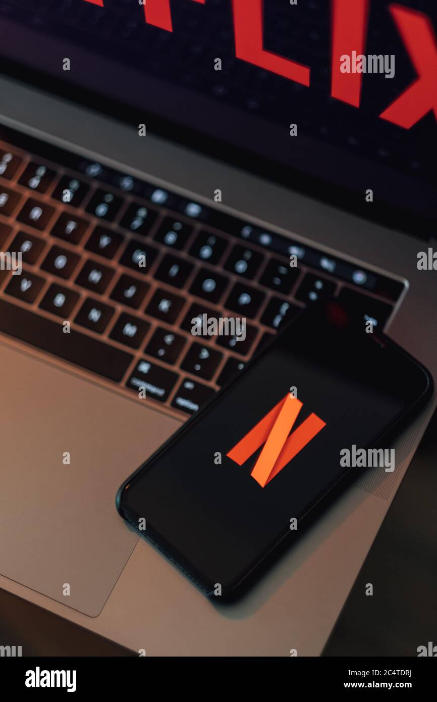 Smartphone and laptop with screen of Netflix logo Stock Photo - Alamy