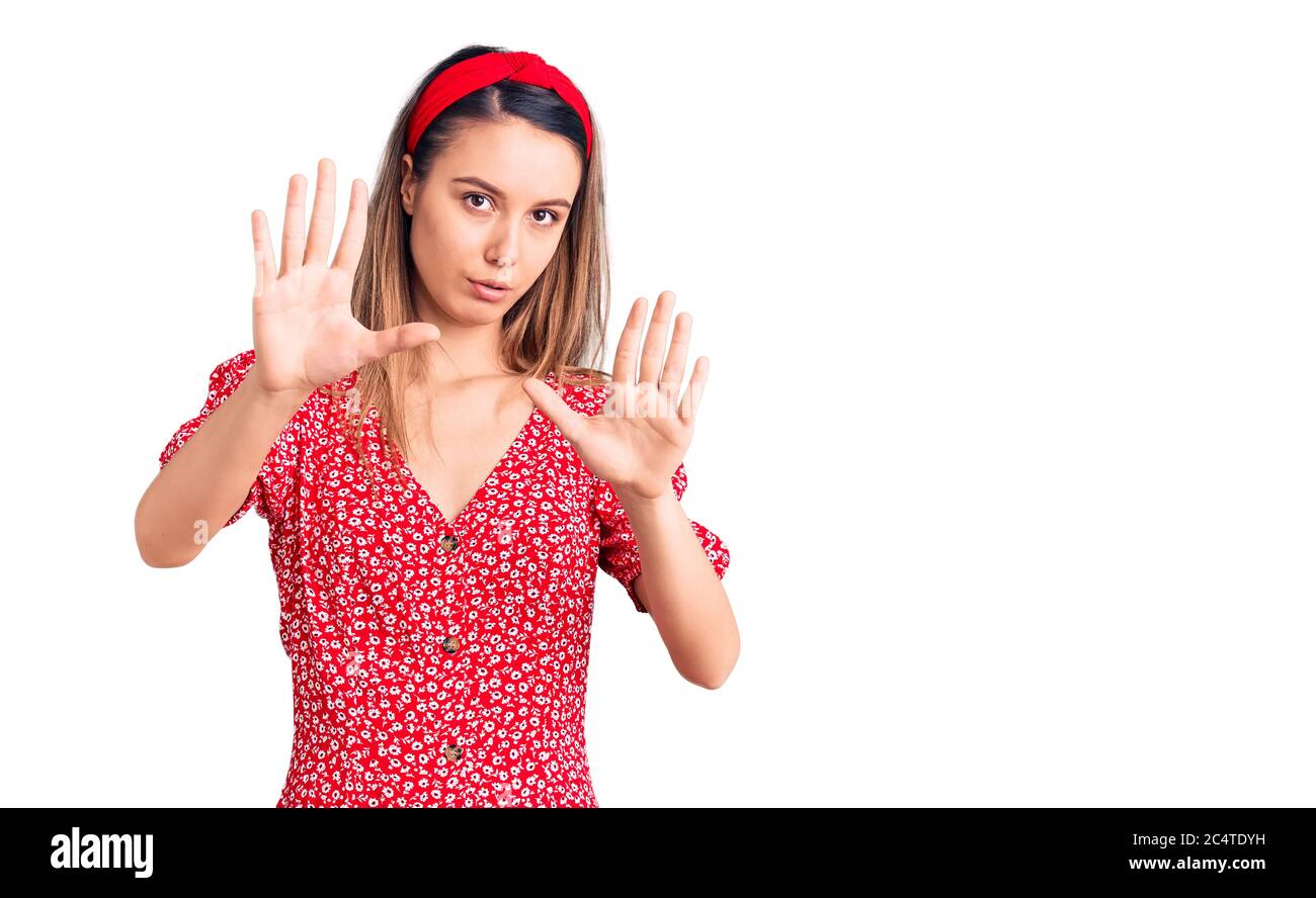 Young beautiful girl wearing dress and diadem moving away hands palms ...