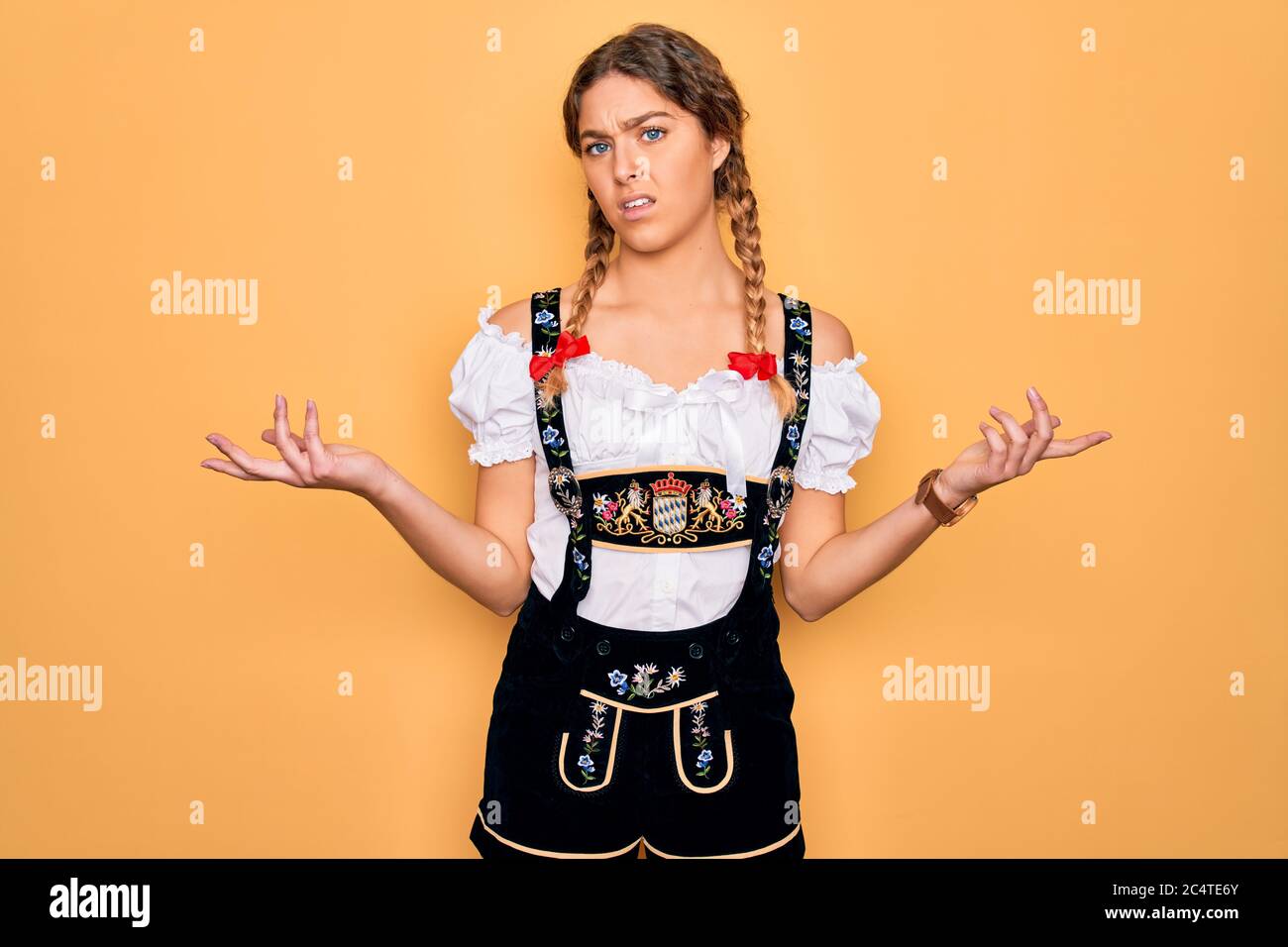 Young beautiful blonde german woman with blue eyes wearing traditional ...
