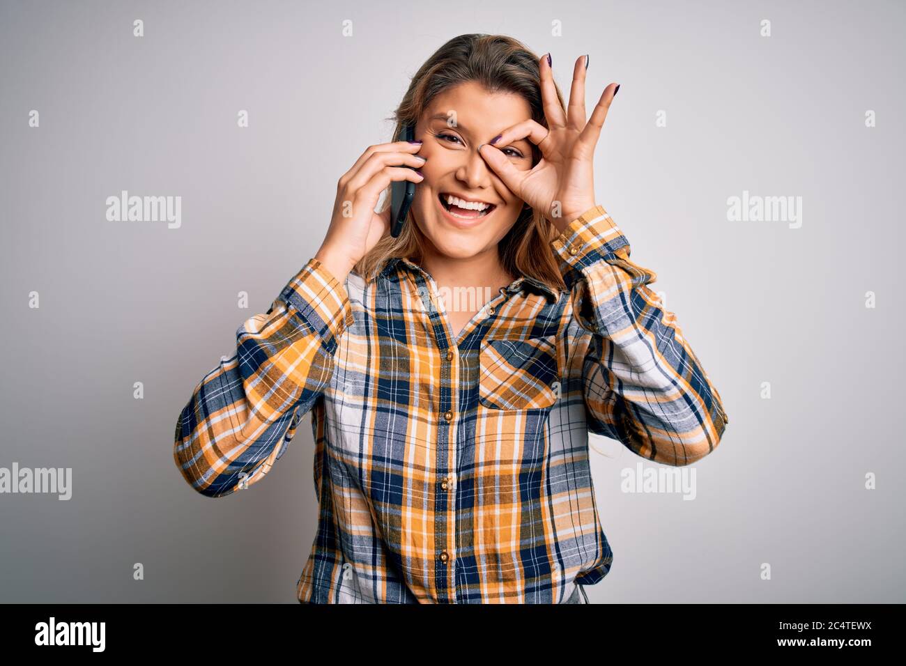 Beautiful blonde woman having conversation talking on the smartphone ...