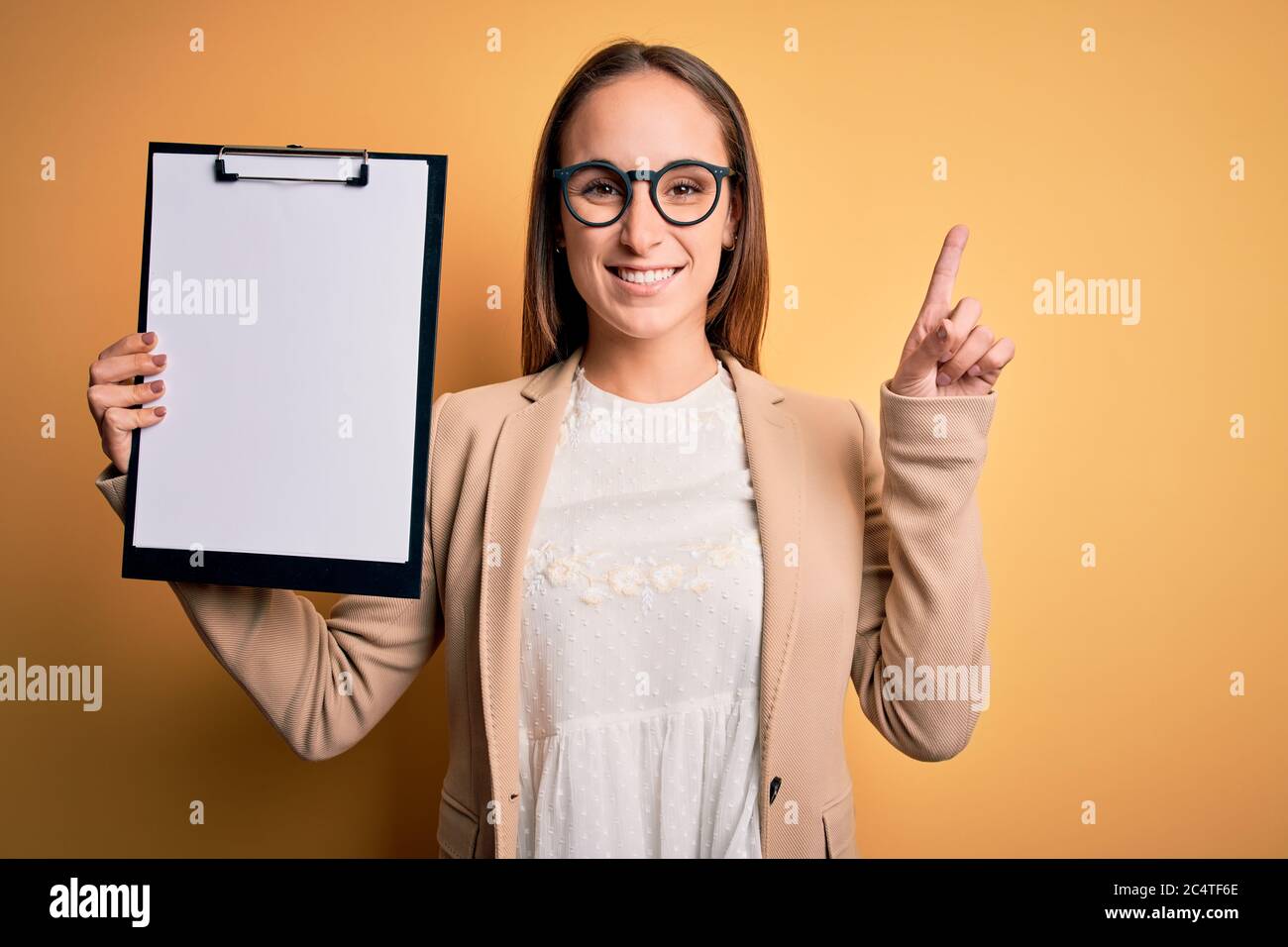 Beautiful inspector woman wearing glasses holding checklist clipboard ...