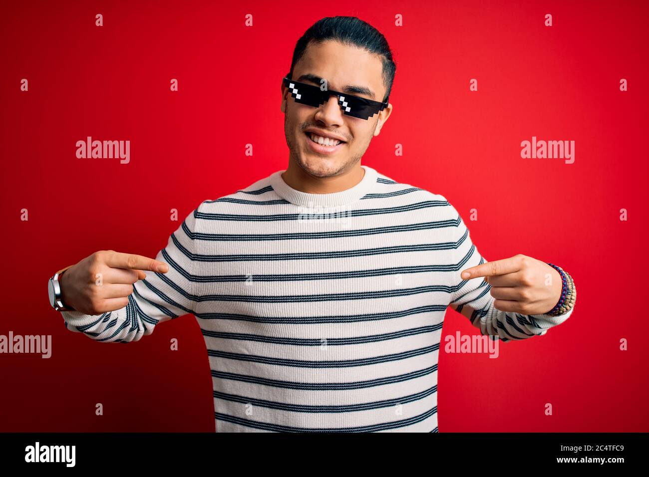 Young brazilian man wearing funny thug life sunglasses over isolated ...