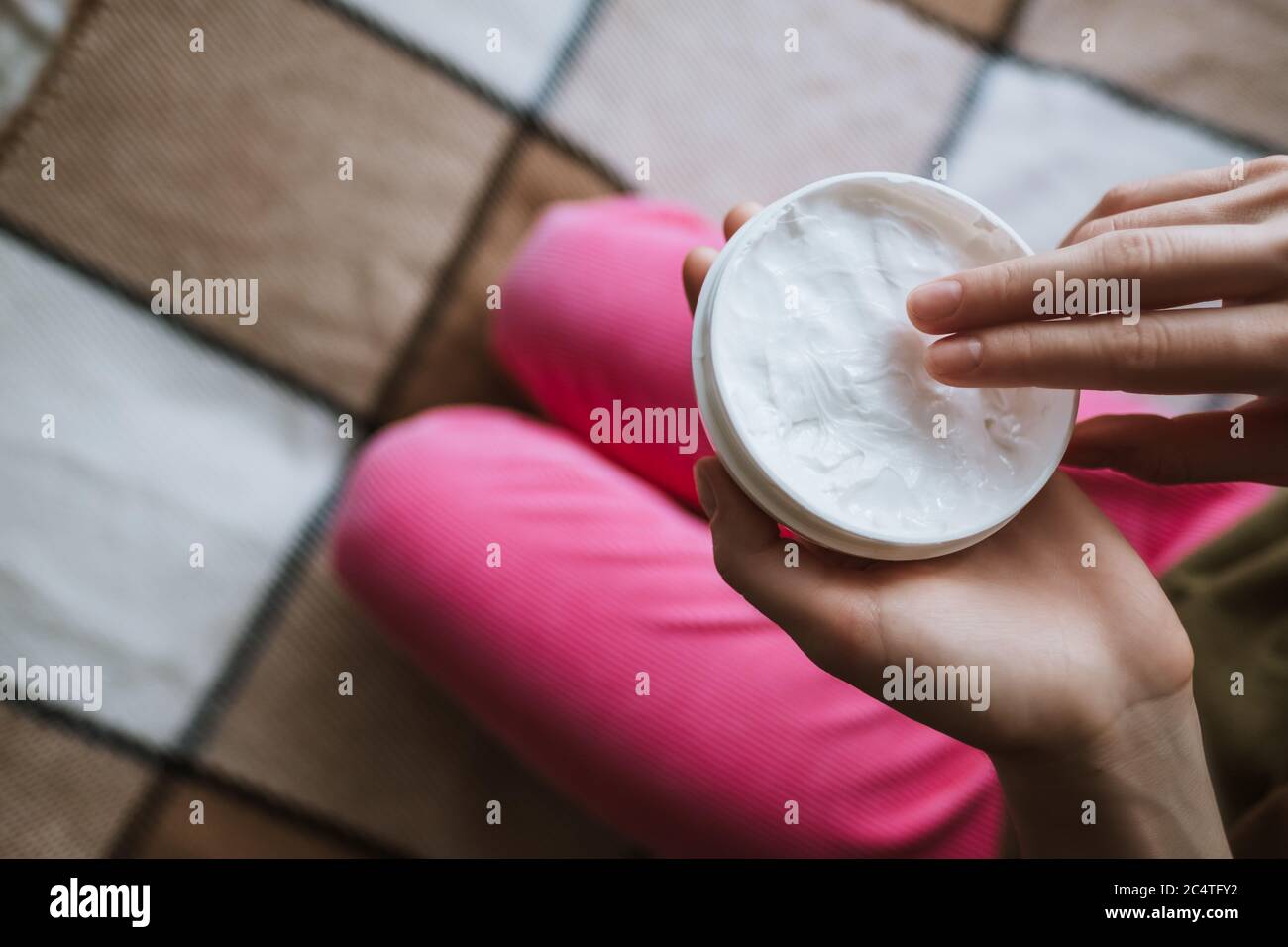 Young female uses body cream Stock Photo - Alamy