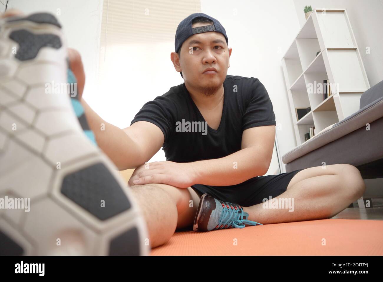 Asian male doing exercise at home to stay healthy on new normal ...