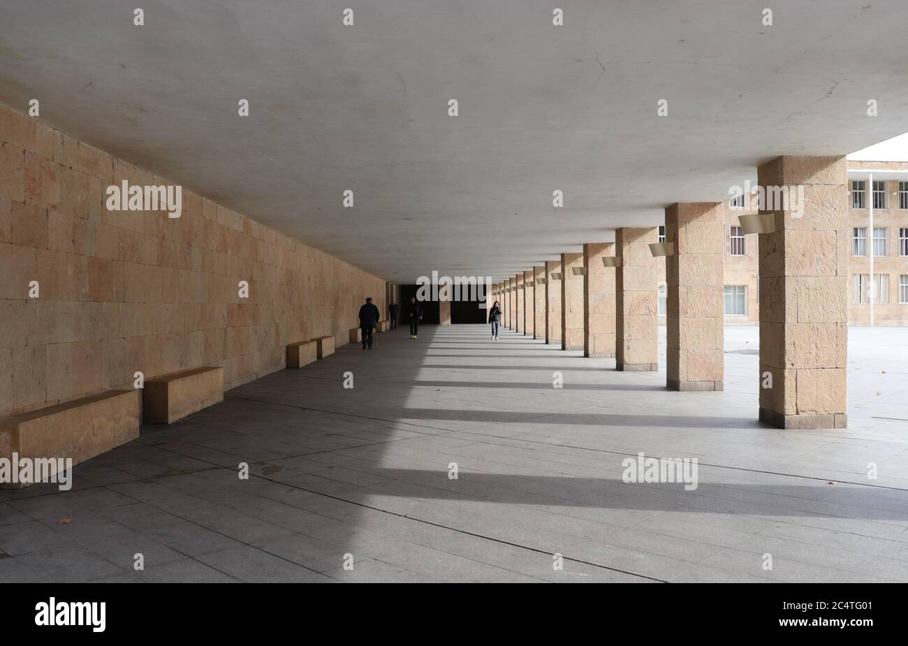 Long corridor of a building with columns on one side Stock Photo - Alamy