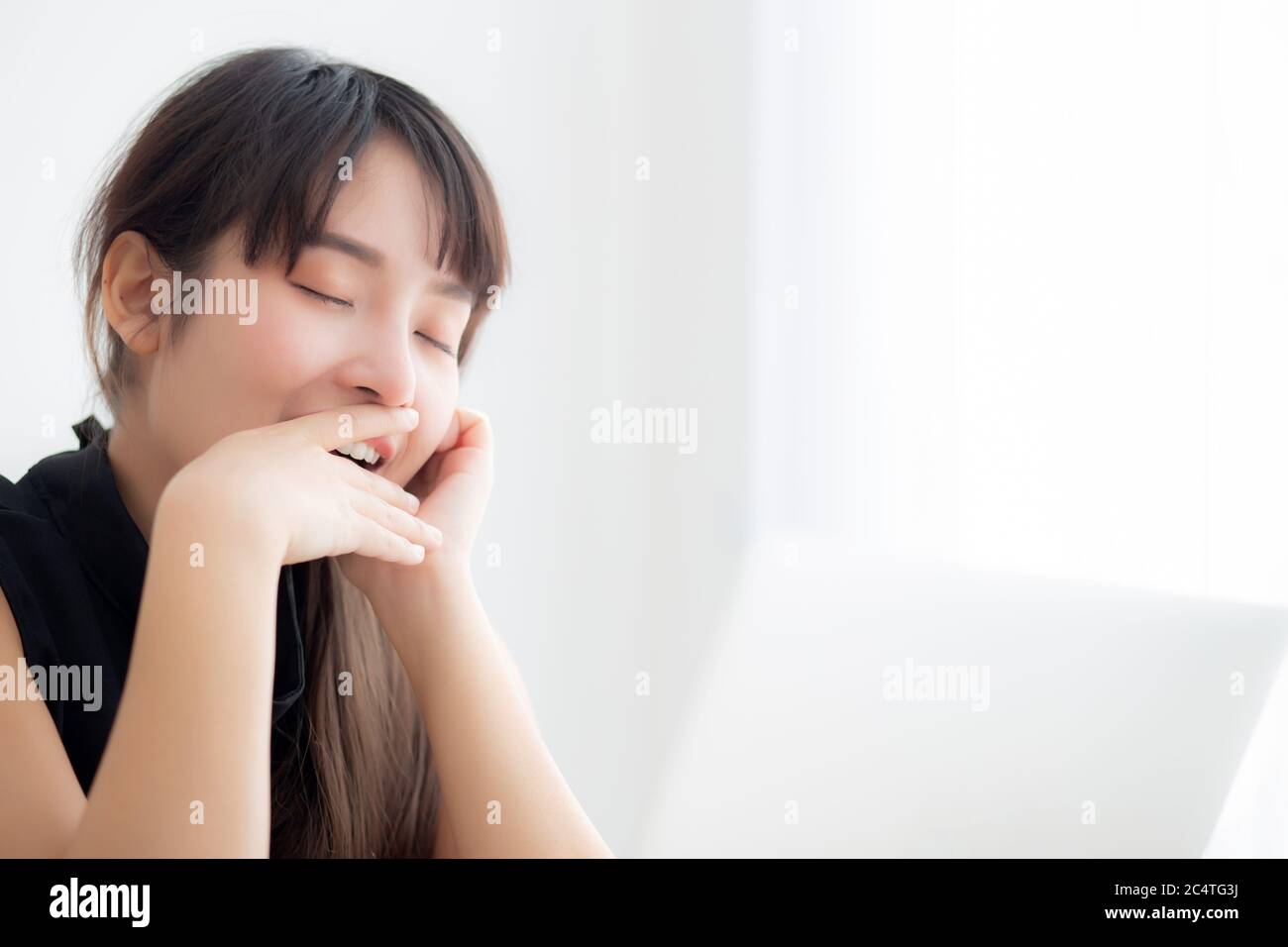 beautiful young freelance asian woman working bored and tired on laptop ...