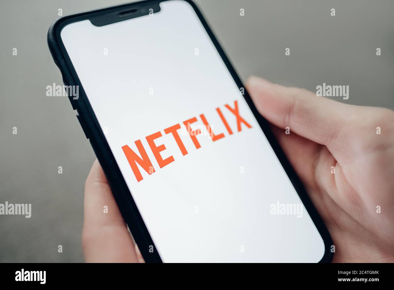 Netflix logo on iphone screen in hand Stock Photo - Alamy