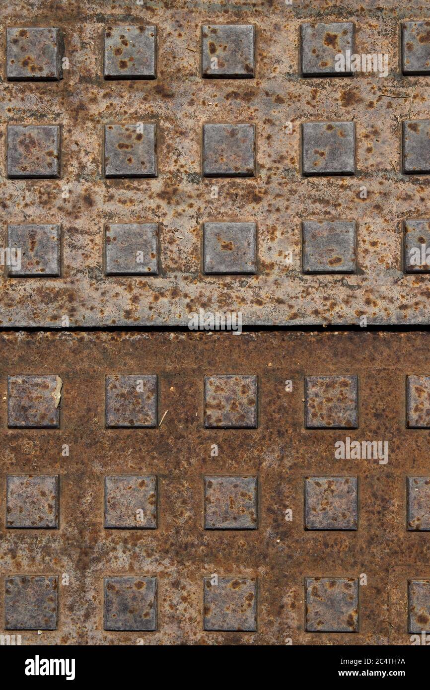 Vertical shot of squares on rusty metal surfaces on top of each other ...