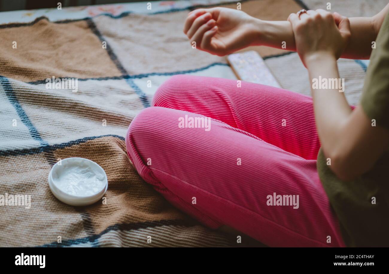 Young female uses body cream Stock Photo - Alamy