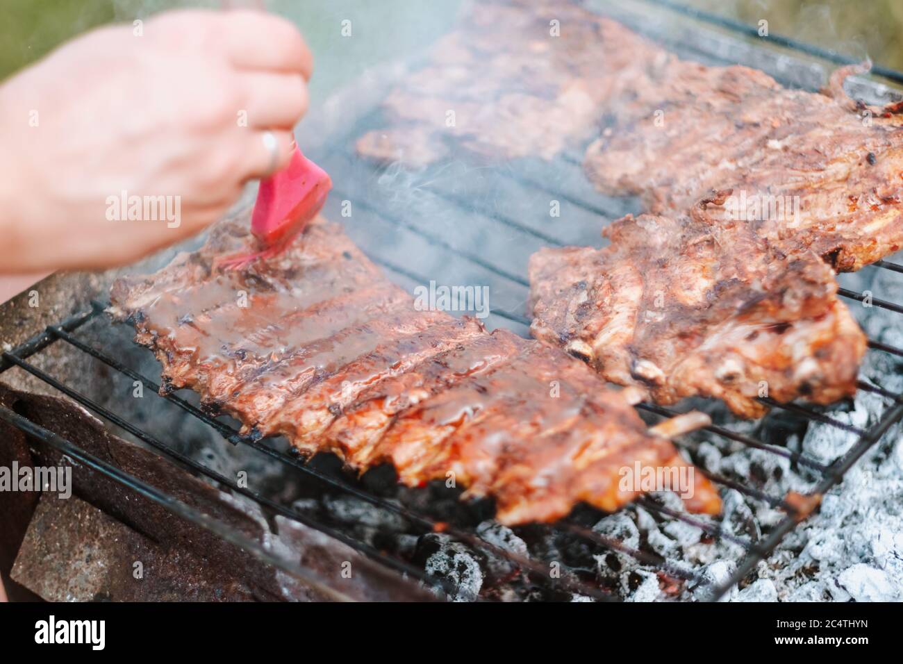 Cooking pork ribs on the grill Stock Photo - Alamy
